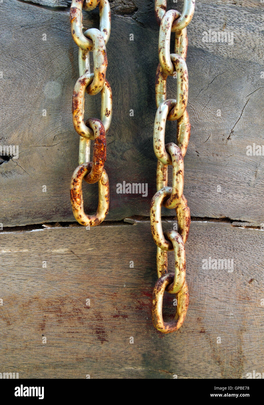 Old rusty chain on wooden background Stock Photo - Alamy