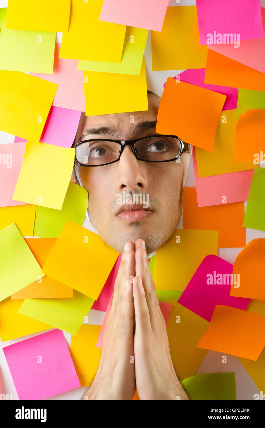 Man's face through paper and reminders Stock Photo - Alamy