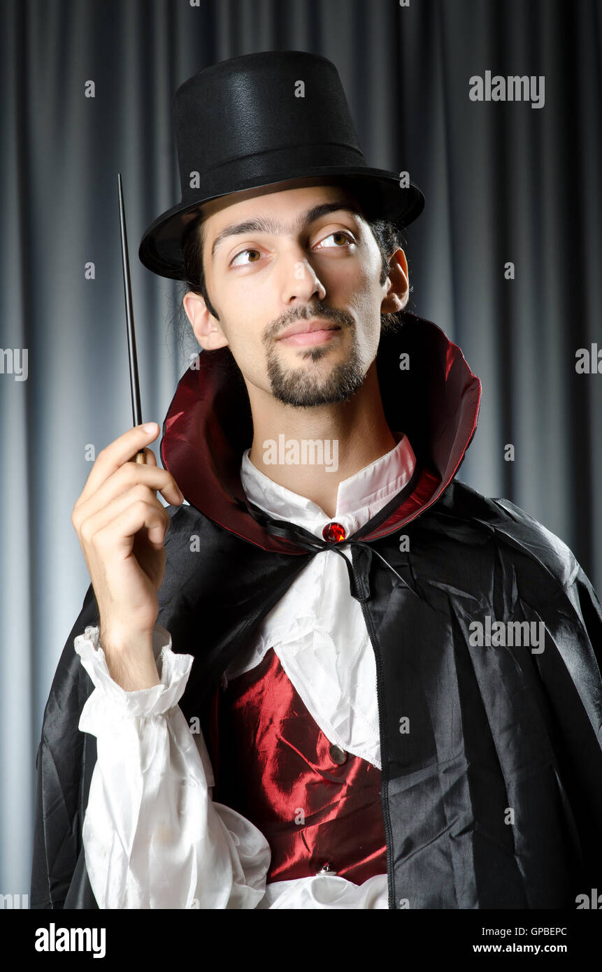 Magician doing tricks on white Stock Photo - Alamy