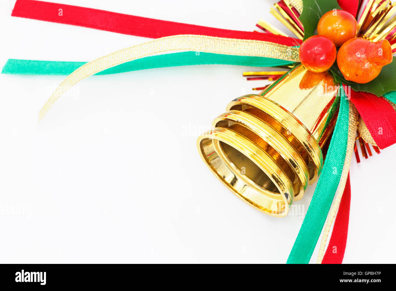 Golden bells with a color ribbon on white background Stock Photo - Alamy