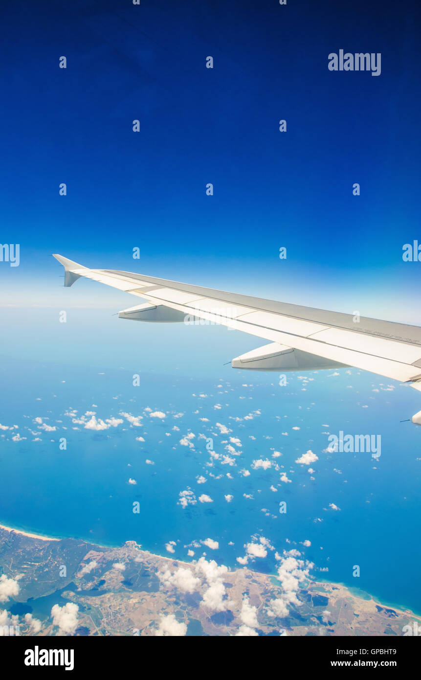 Airplane wing out of window Stock Photo - Alamy