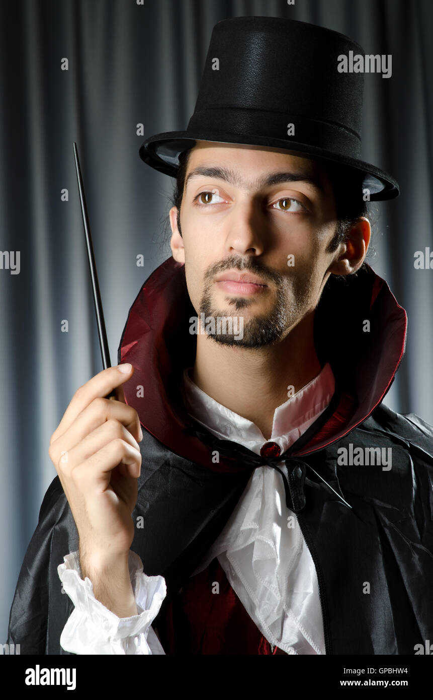 Magician doing tricks on white Stock Photo - Alamy
