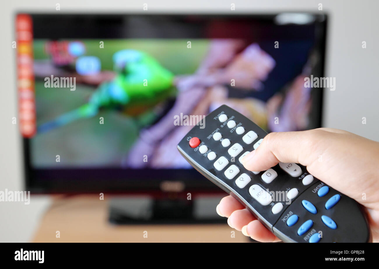 Hand pointing a tv remote control towards the television Stock Photo ...