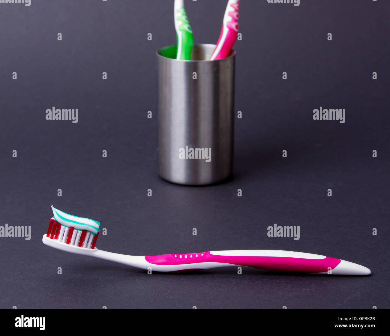 A pink toothbrush with toothpaste Stock Photo - Alamy
