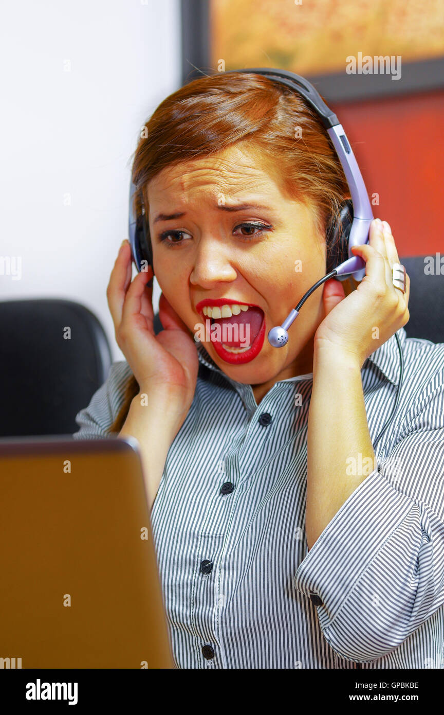 Young attractive woman wearing office clothes and headset sitting by ...