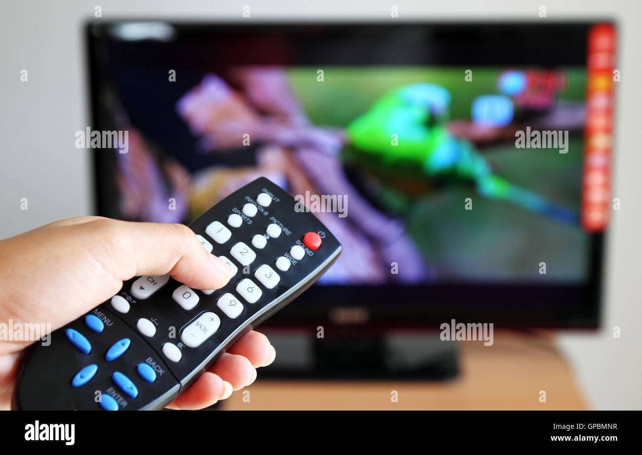 Hand pointing a tv remote control towards the television Stock Photo ...