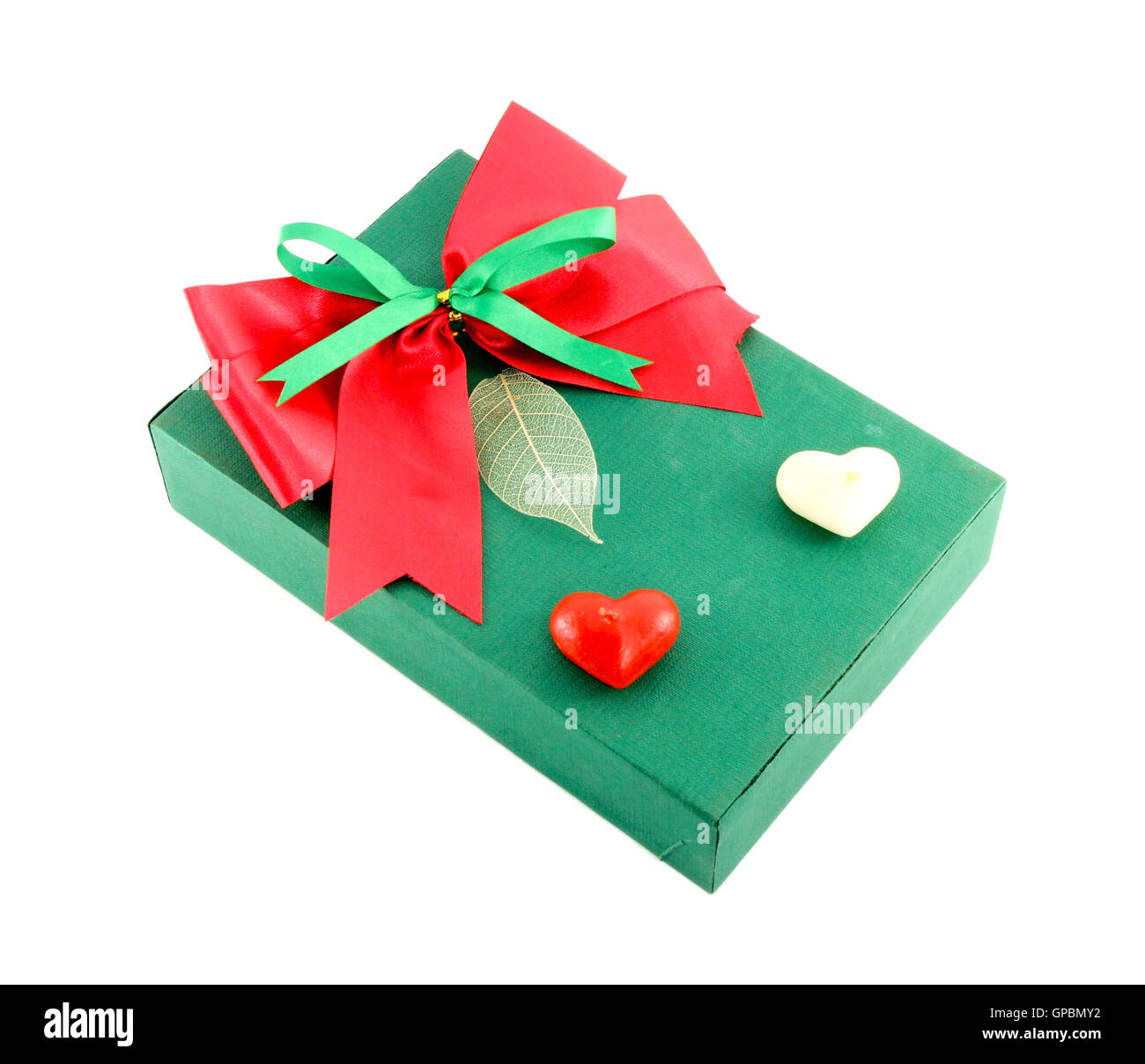 green gift box with red ribbon on white background Stock Photo - Alamy