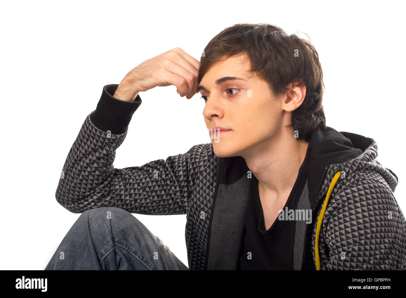 Young man sitting and thinking Stock Photo - Alamy