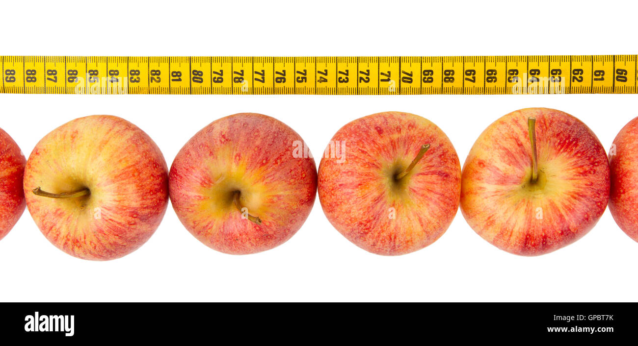 Red apples with a yellow tape-measure Stock Photo - Alamy
