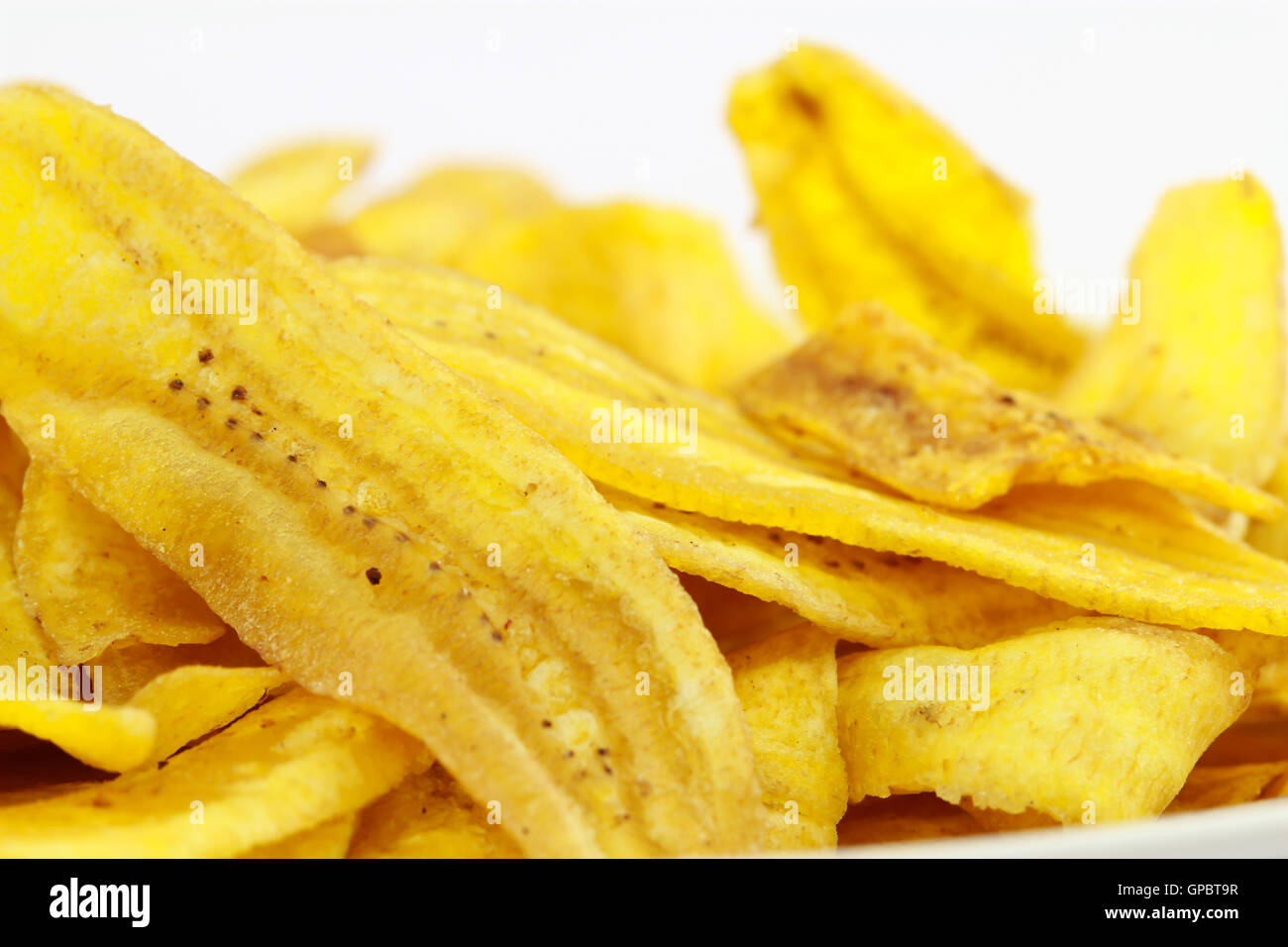 Fried thinly sliced banana chips, a tropical snack Stock Photo - Alamy