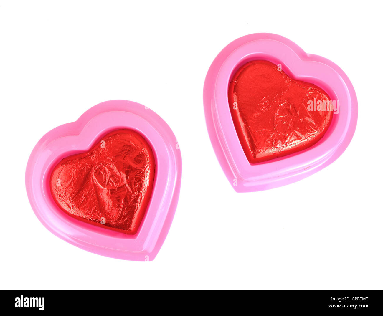 Red Foil wrapped chocolate hearts Stock Photo - Alamy