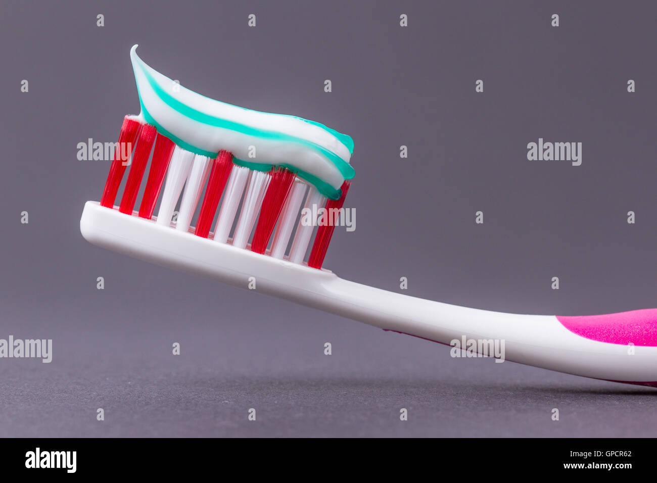 A pink toothbrush with toothpaste Stock Photo - Alamy