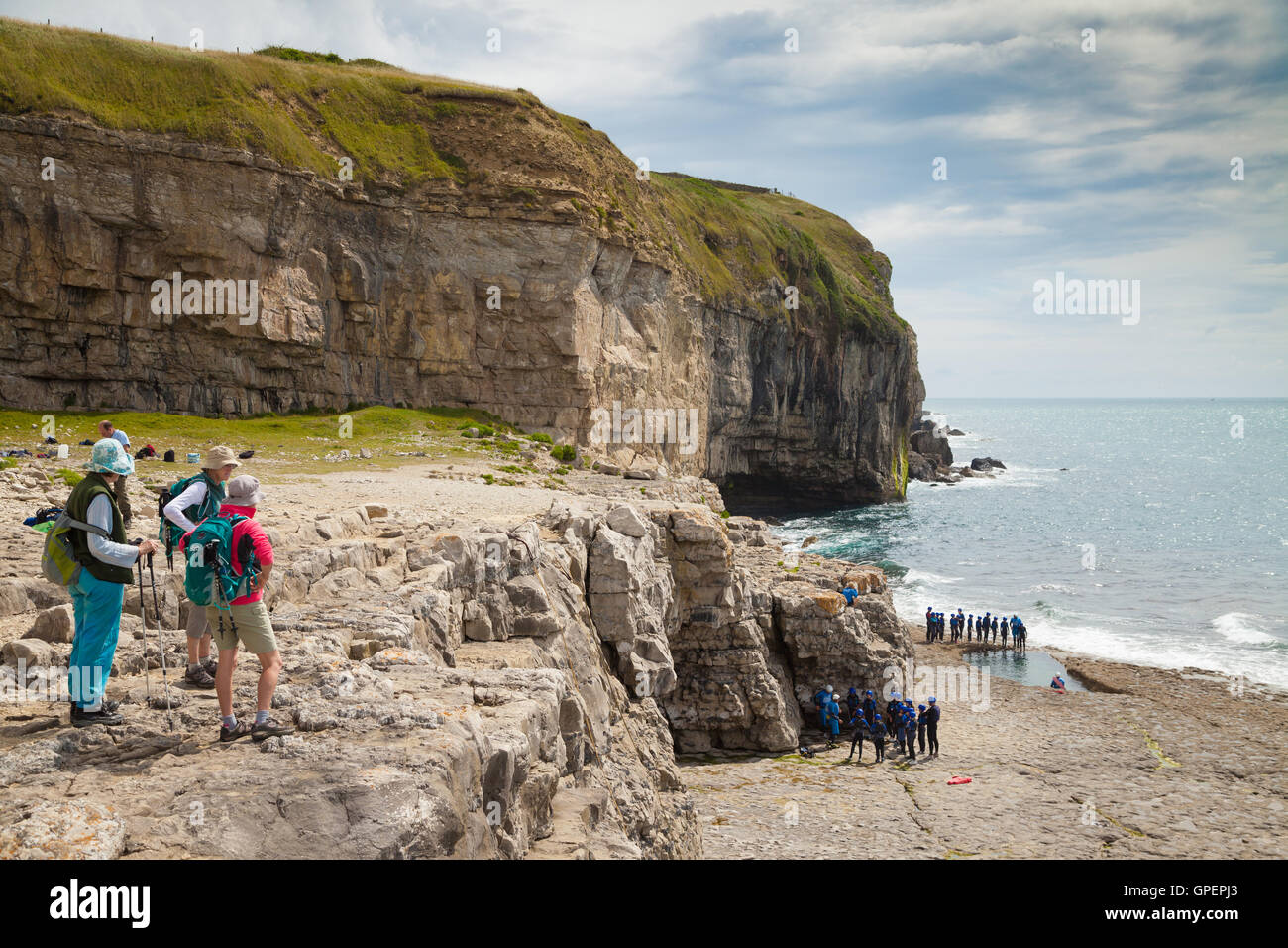Walkers looking over school children heading off to do coasteering on ...