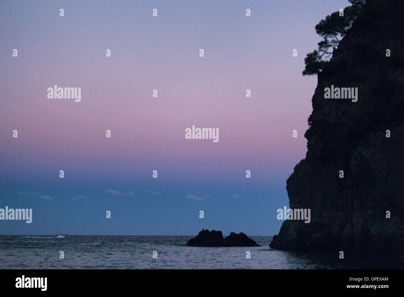 Violet dusk over the Mediterranean Sea in Cala Pedrosa Stock Photo - Alamy
