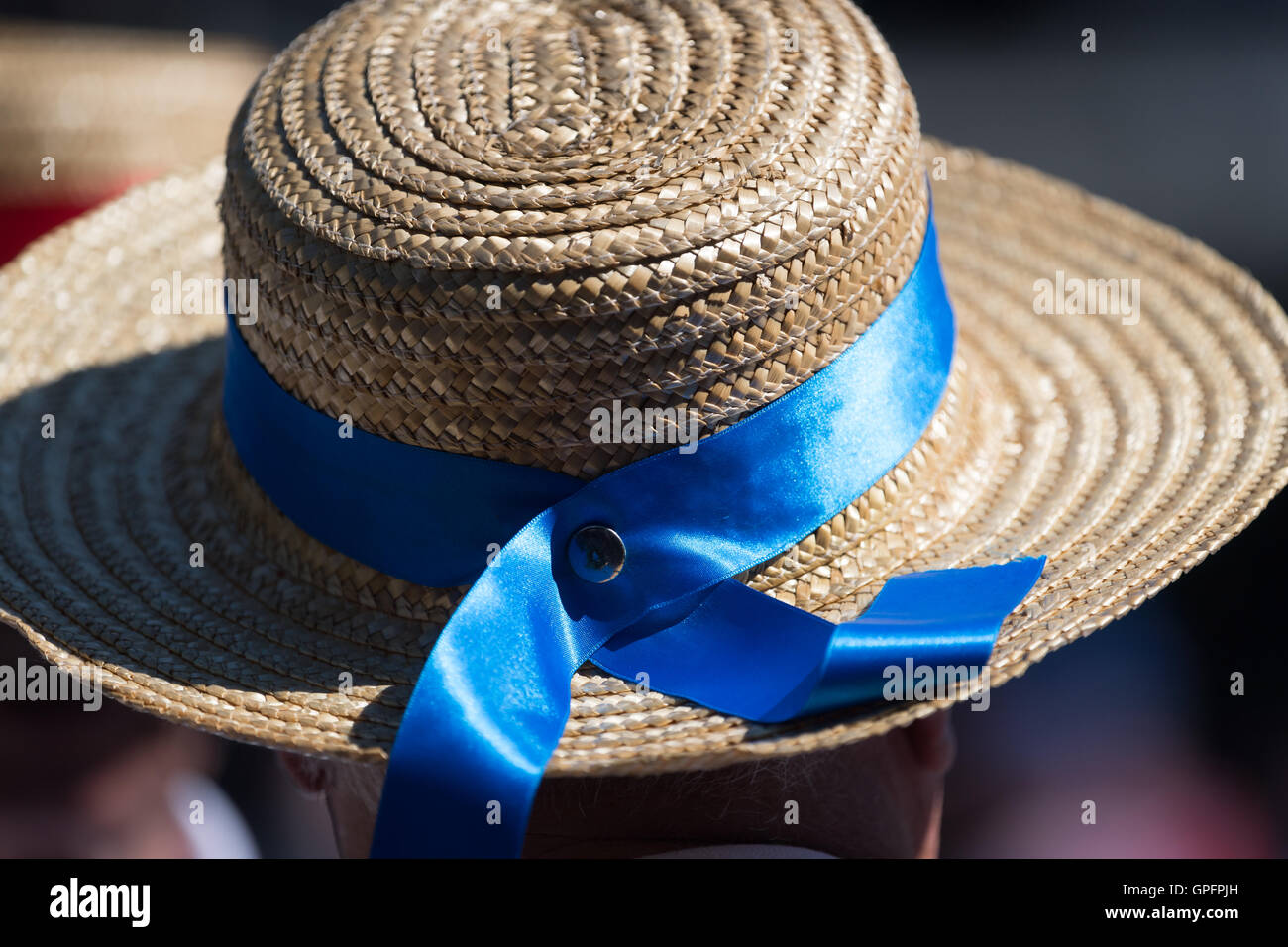Traditional ribboned straw hat worn by cheese carriers in the market of ...