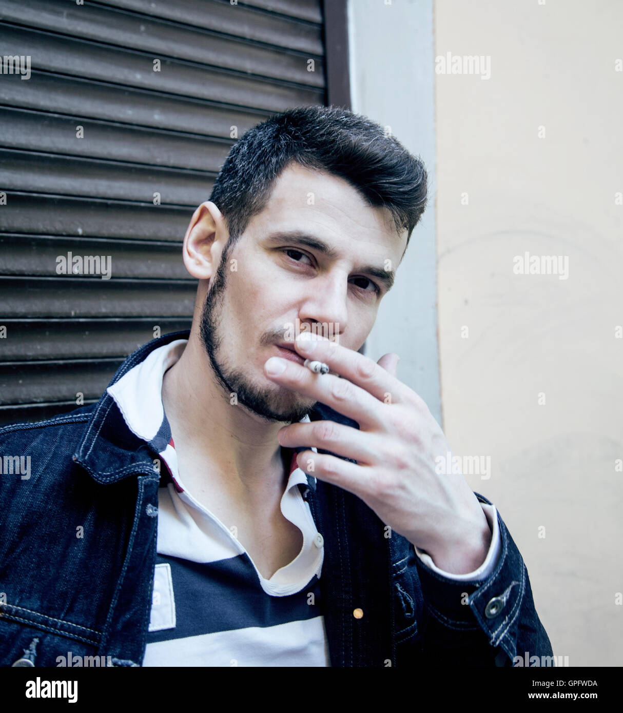 middle age man smoking cigarette on backjard, stylish tough guy ...