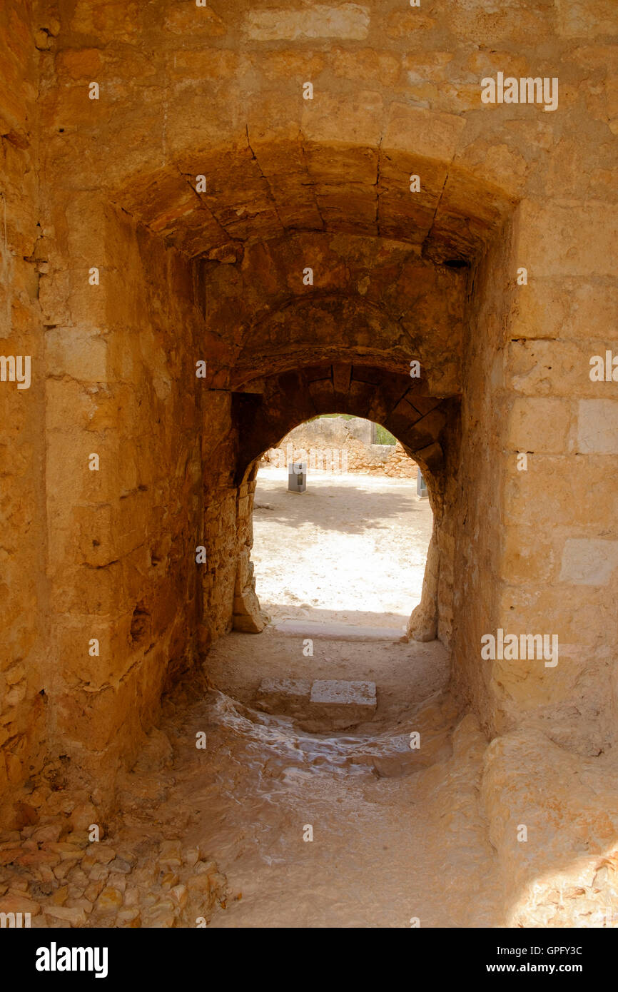 Narrow passageway gate through the walls of Denia Castle Stock Photo ...