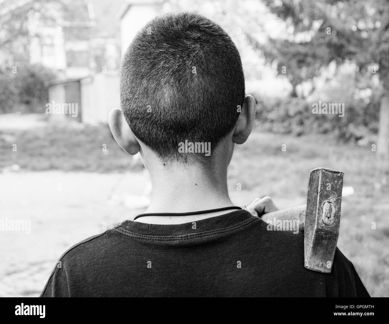 Kid with hammer from back, black and white photo Stock Photo - Alamy