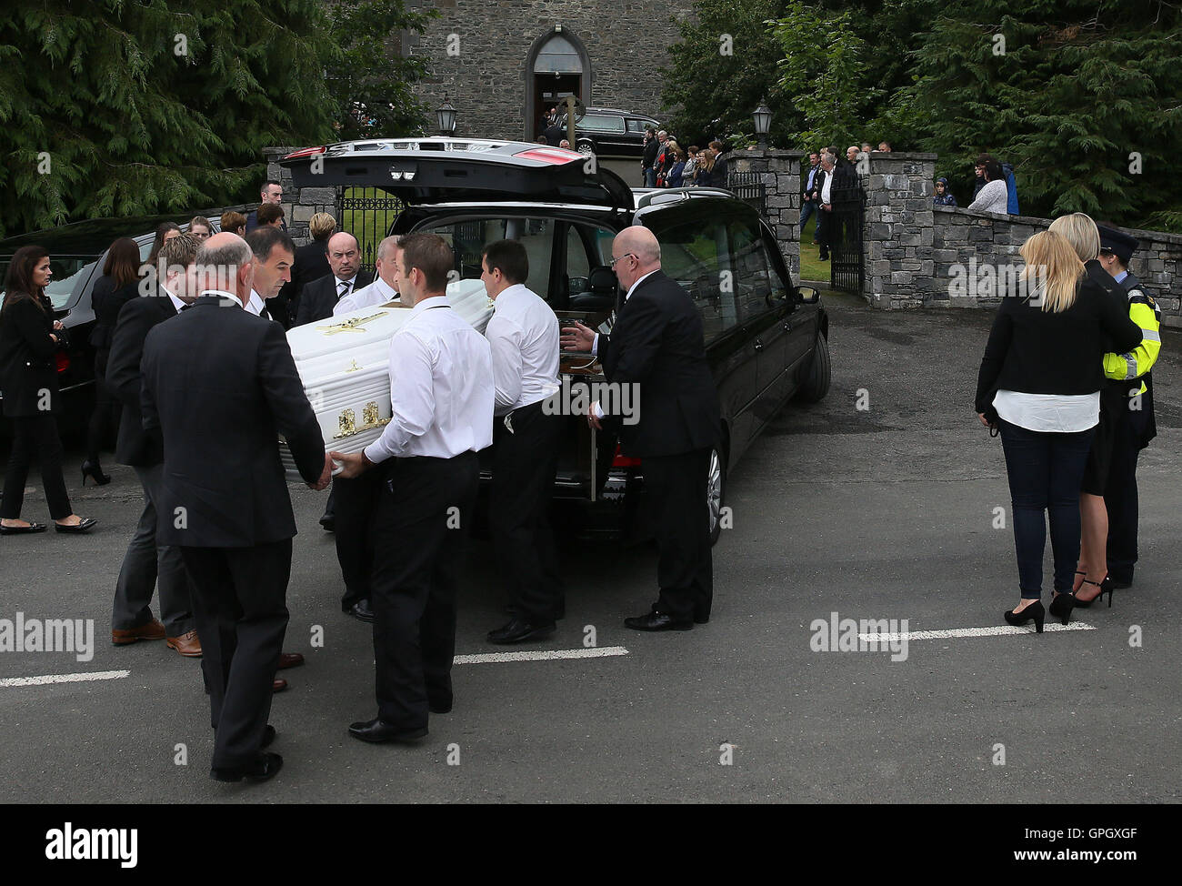 One of the children's coffins is taken into Saint Mary's Church in ...