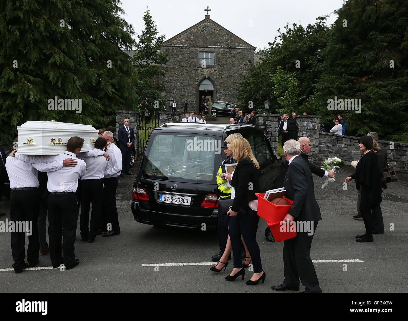 One of the children's coffins is taken into Saint Mary's Church in ...