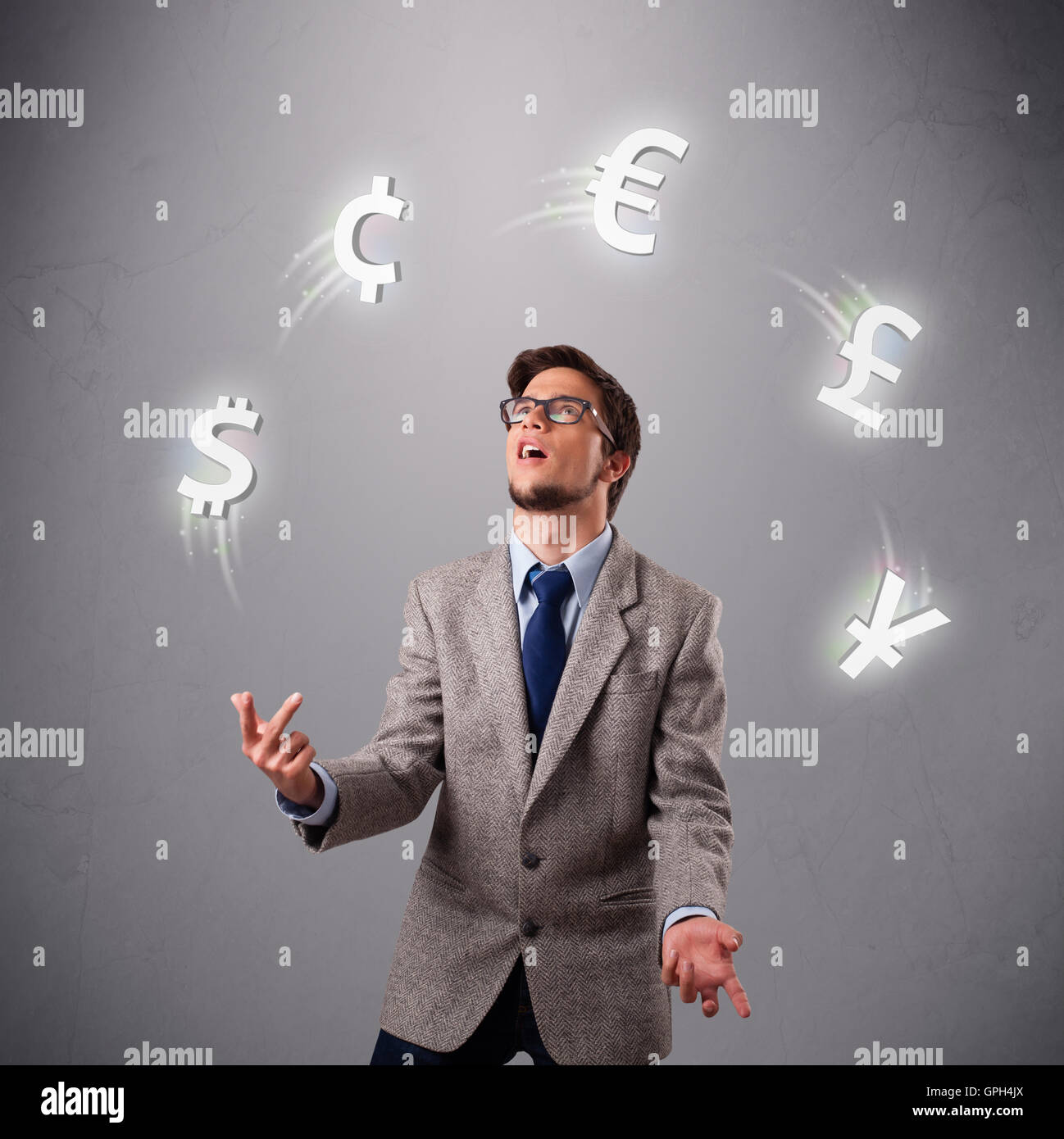 young man standing and juggling with currency icons Stock Photo - Alamy
