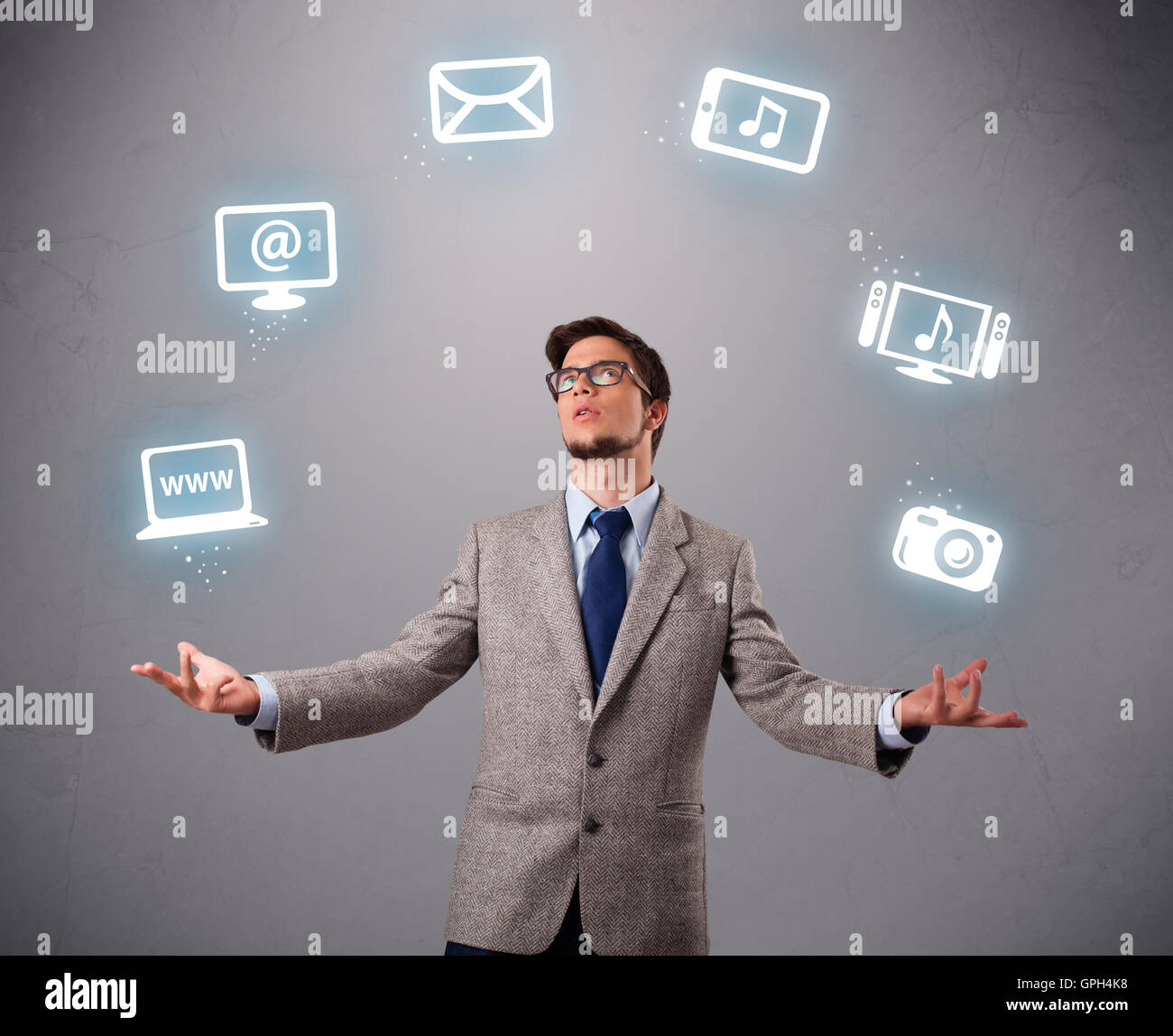 funny boy juggling with electronic devices icons Stock Photo - Alamy