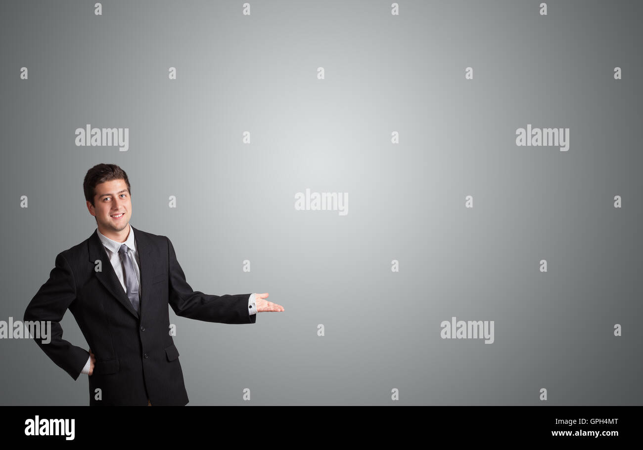 handsome man presenting copy space Stock Photo - Alamy