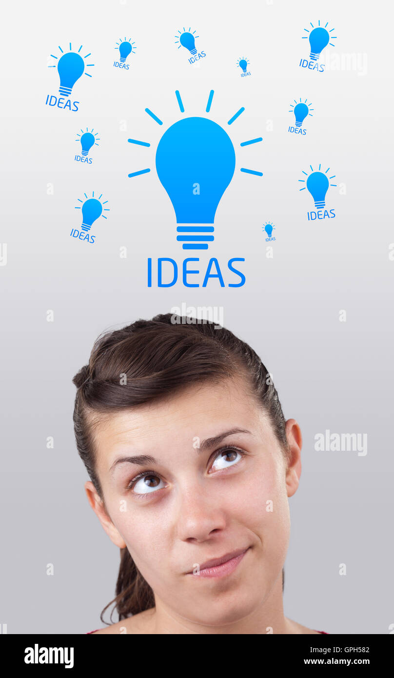 Young girl looking at idea type of sign Stock Photo - Alamy