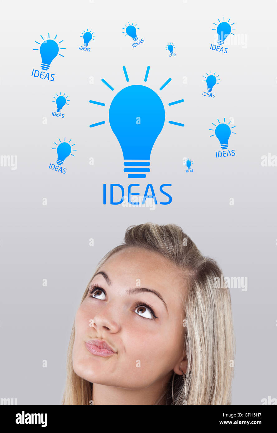 Young girl looking at idea type of sign Stock Photo - Alamy