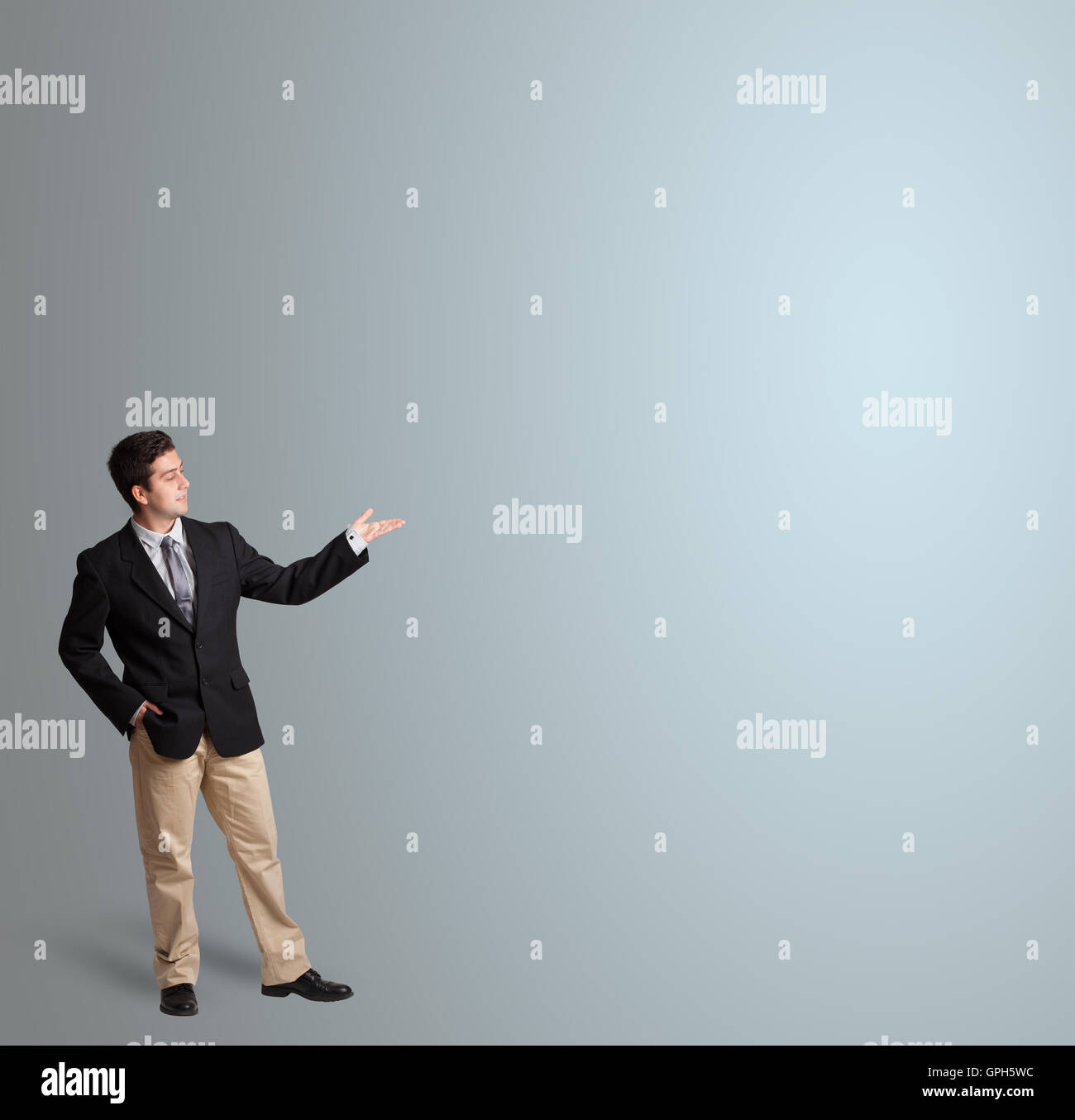 handsome man presenting copy space Stock Photo - Alamy