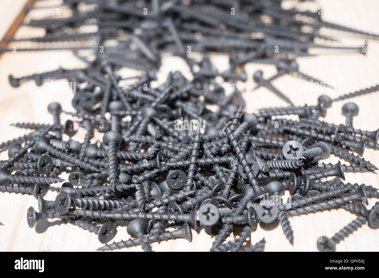 A lot of black metal screws on the surface Stock Photo - Alamy