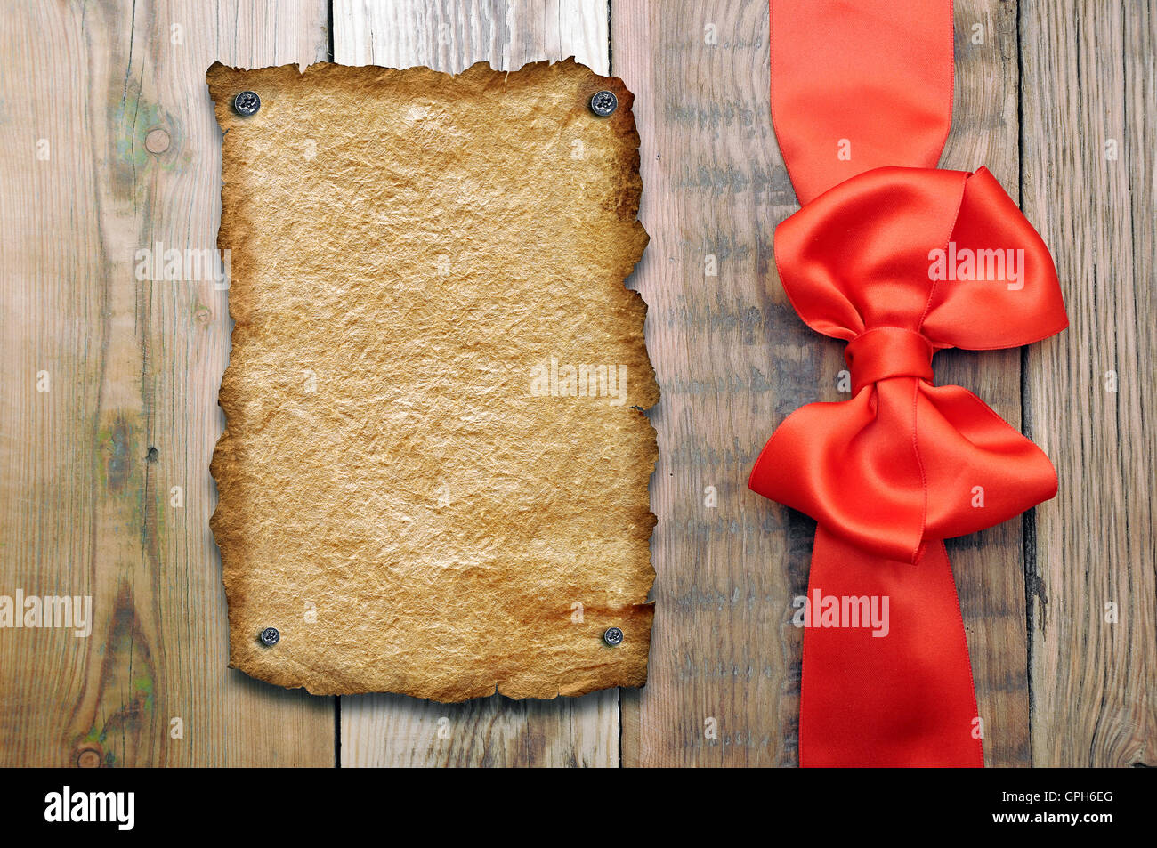 Red bow on blank old paper with copyspace for your text Stock Photo - Alamy