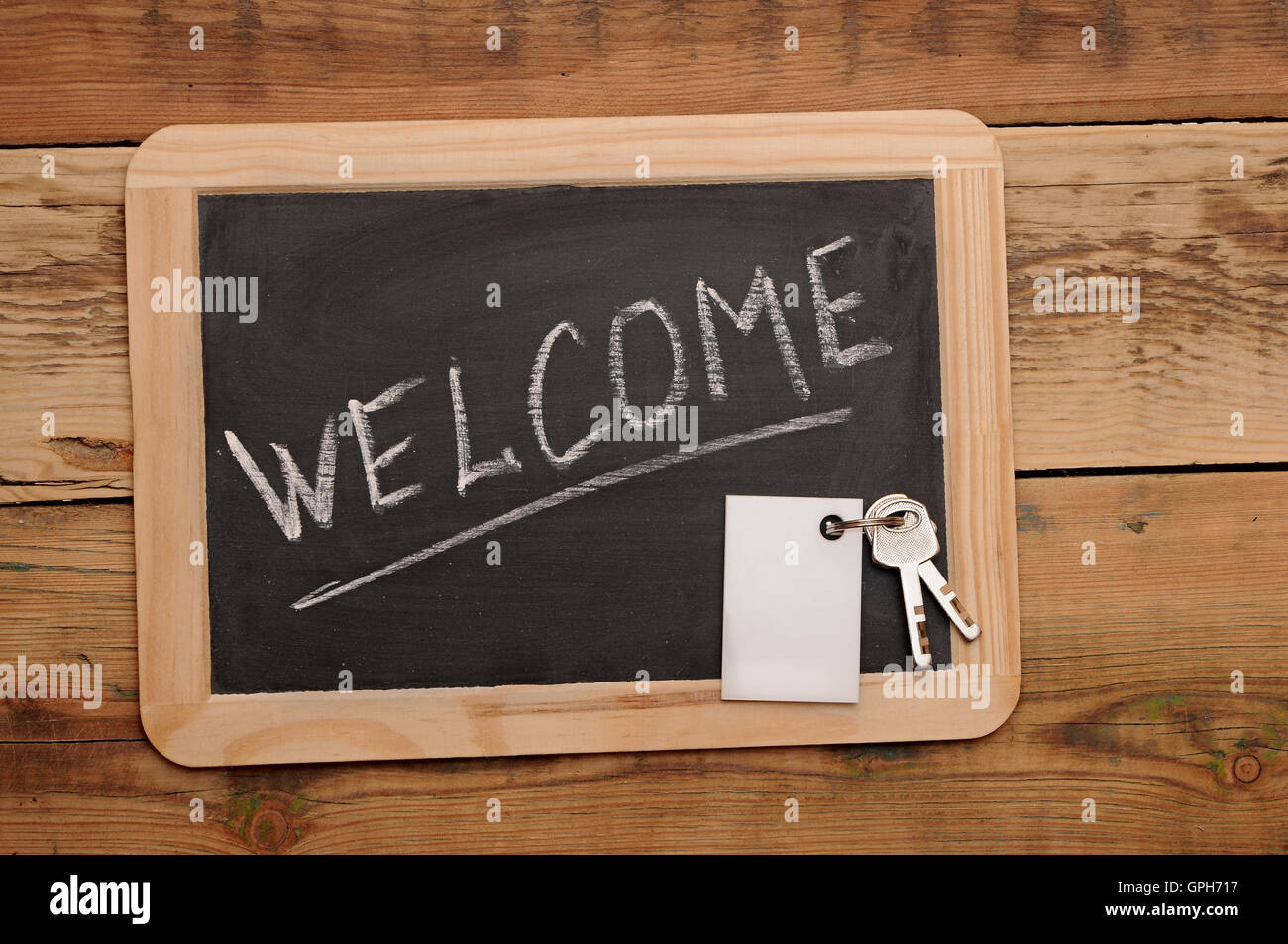 word "welcome" and key on small school wooden blackboard Stock Photo ...