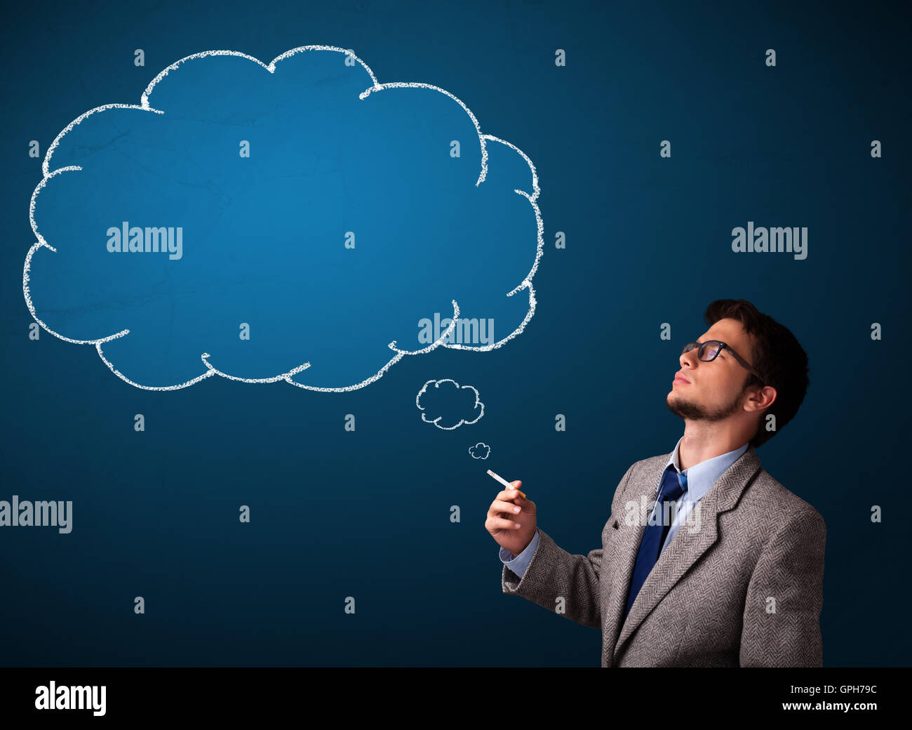 Young man smoking cigarette with idea cloud Stock Photo - Alamy