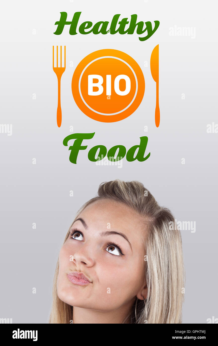 Young girl looking at healthy food sign Stock Photo - Alamy