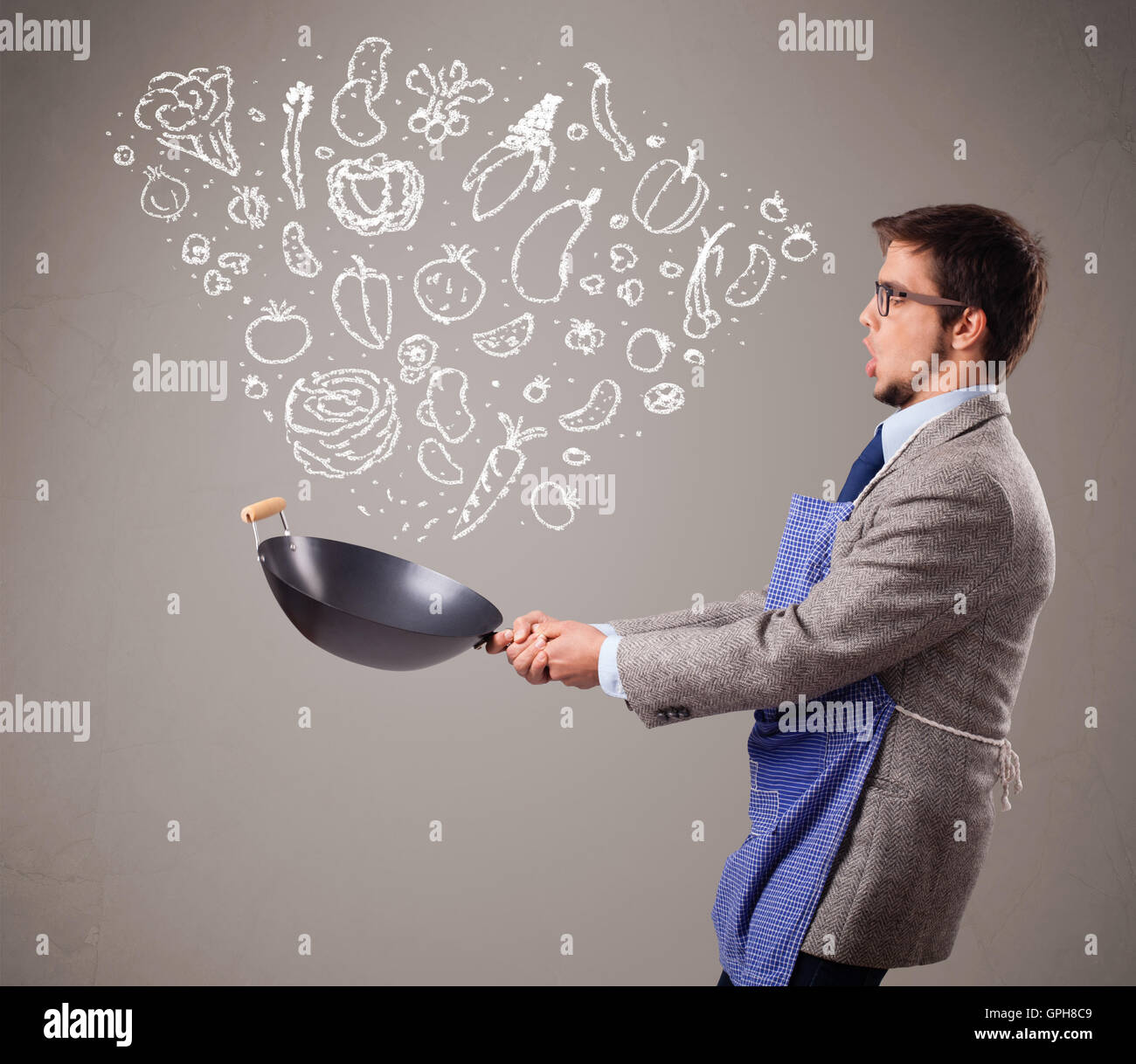 Attractive man cooking vegetables Stock Photo - Alamy