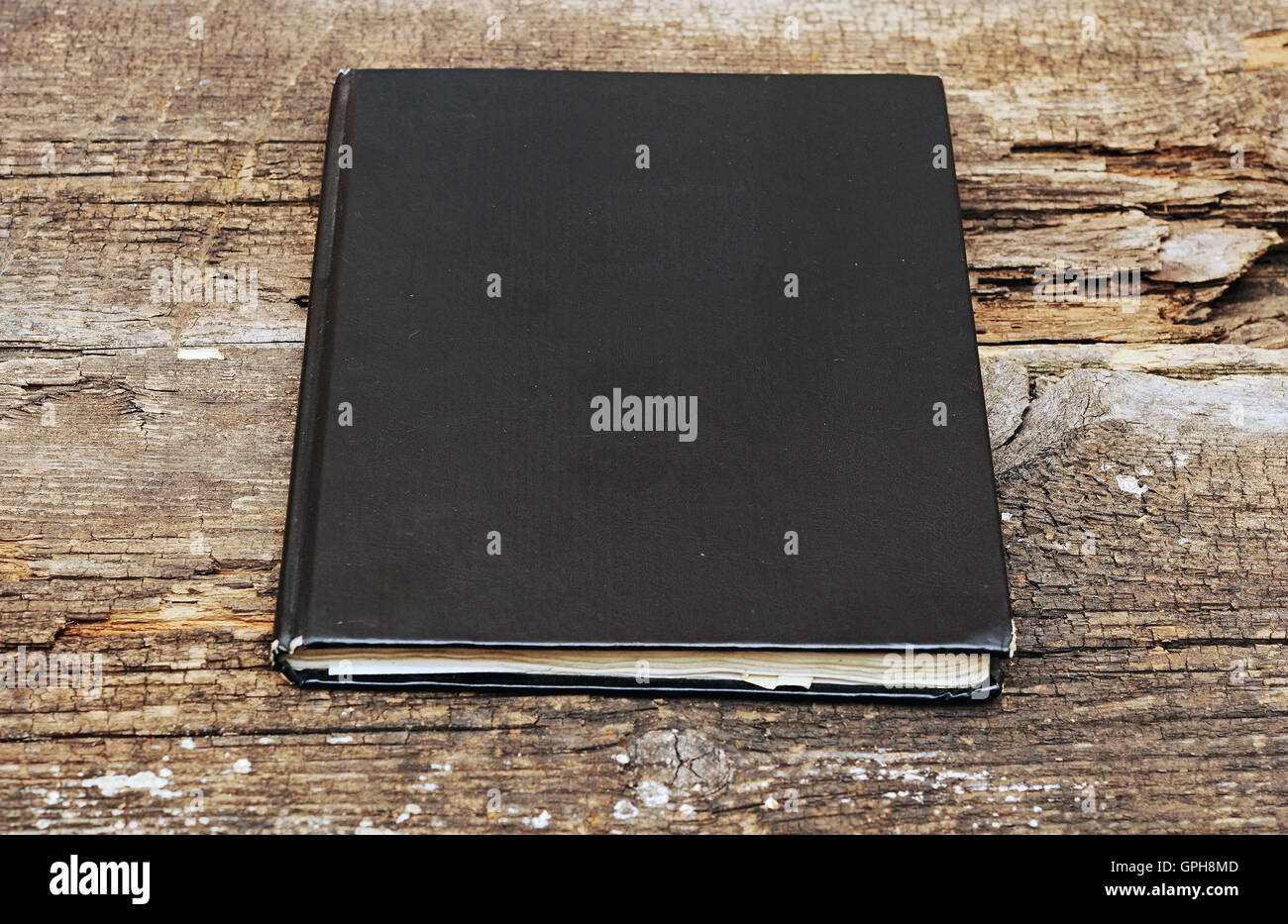 black leather notebook on wooden background Stock Photo - Alamy