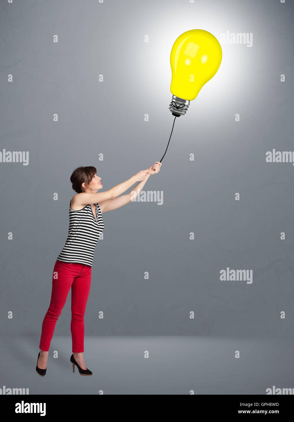 Pretty lady holding a light bulb balloon Stock Photo - Alamy