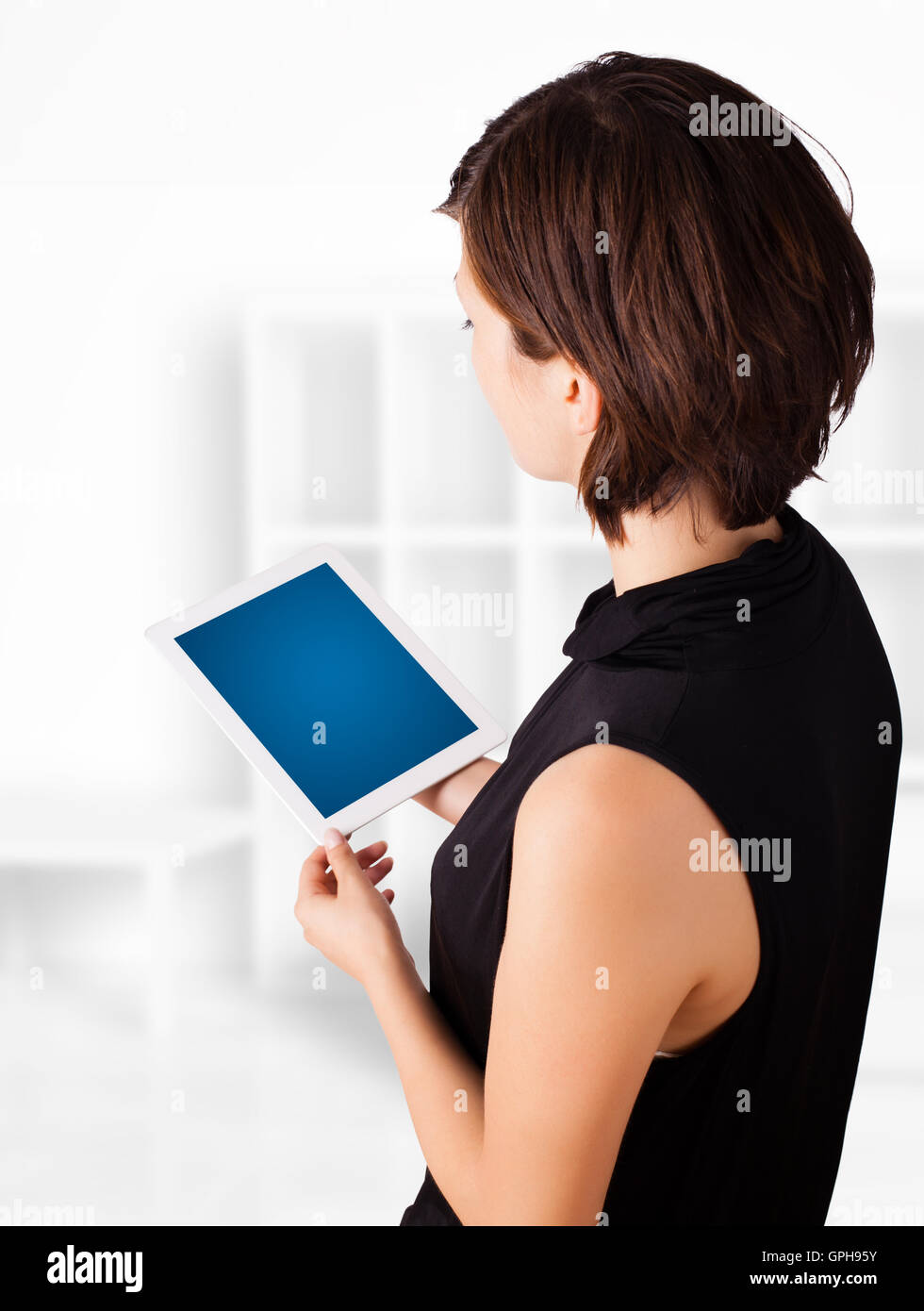 Young woman looking at modern tablet Stock Photo - Alamy