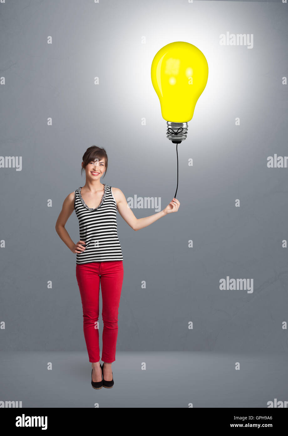 Pretty lady holding a light bulb balloon Stock Photo - Alamy