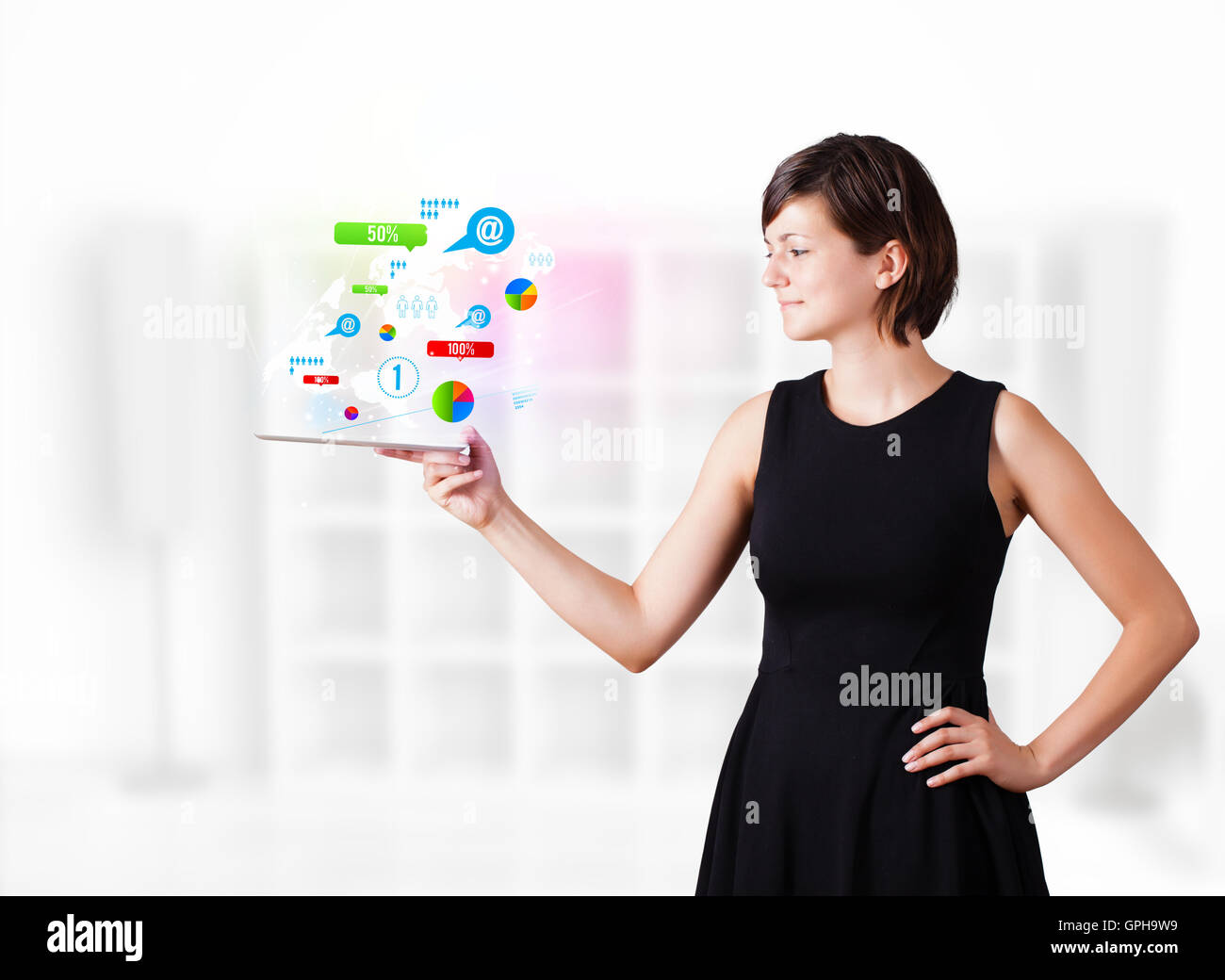 Young woman looking at modern tablet with colourful technology i Stock ...