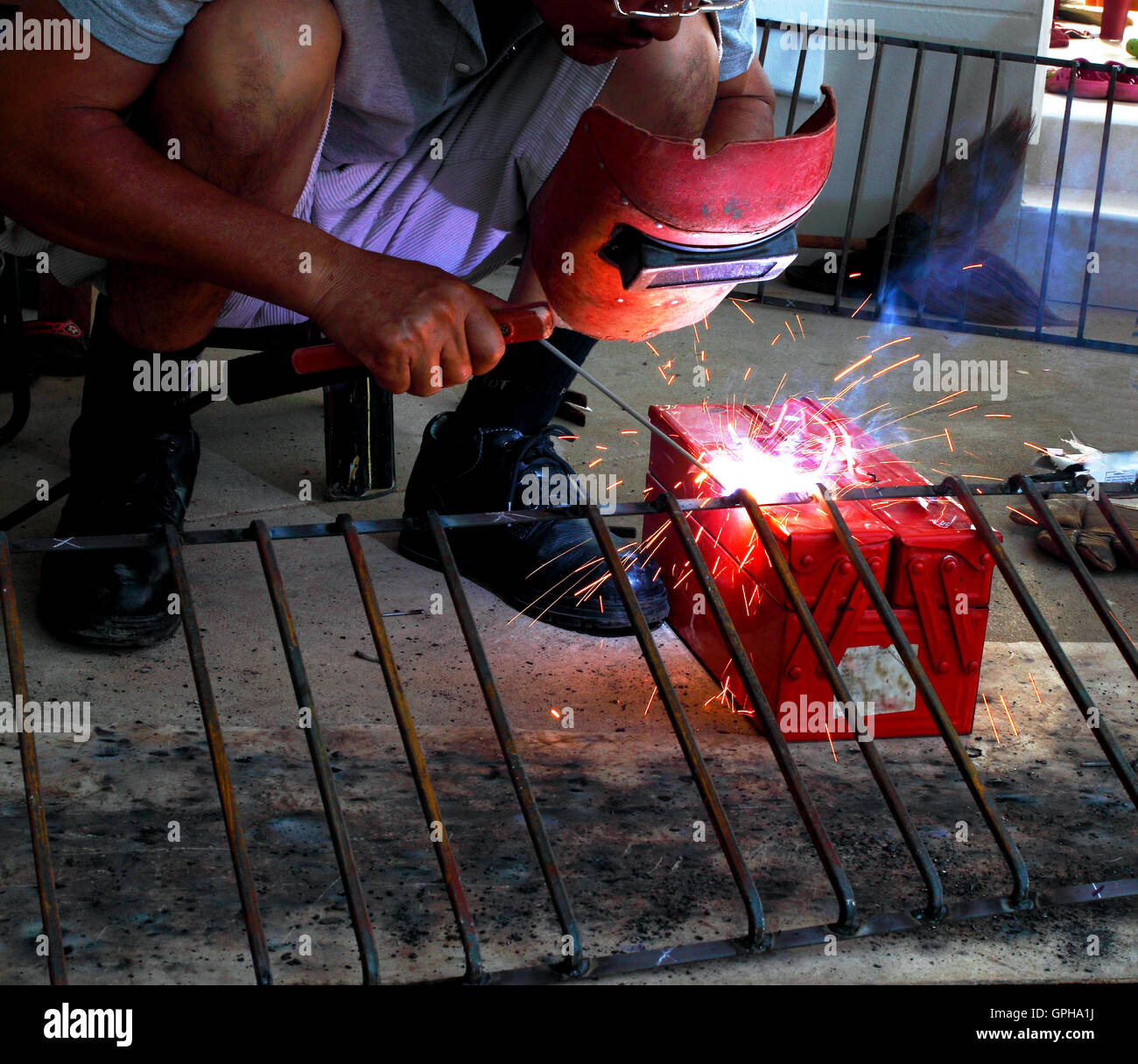 worker welding connecting square bar Stock Photo - Alamy