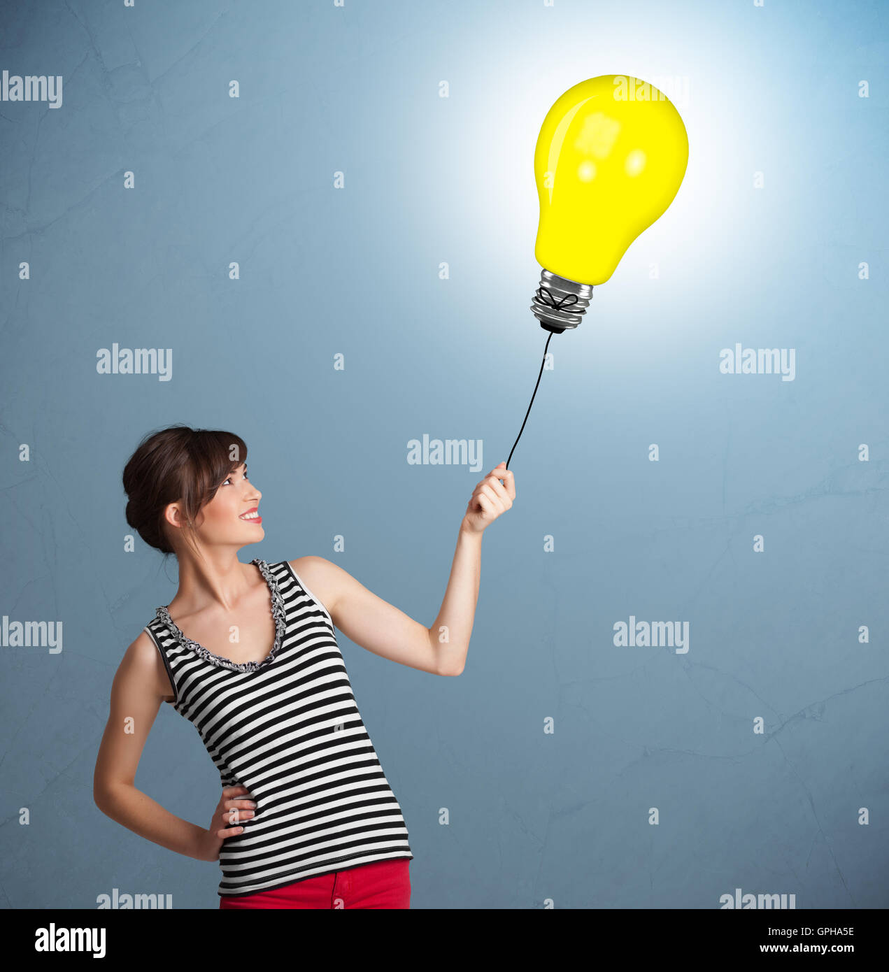 Pretty lady holding a light bulb balloon Stock Photo - Alamy