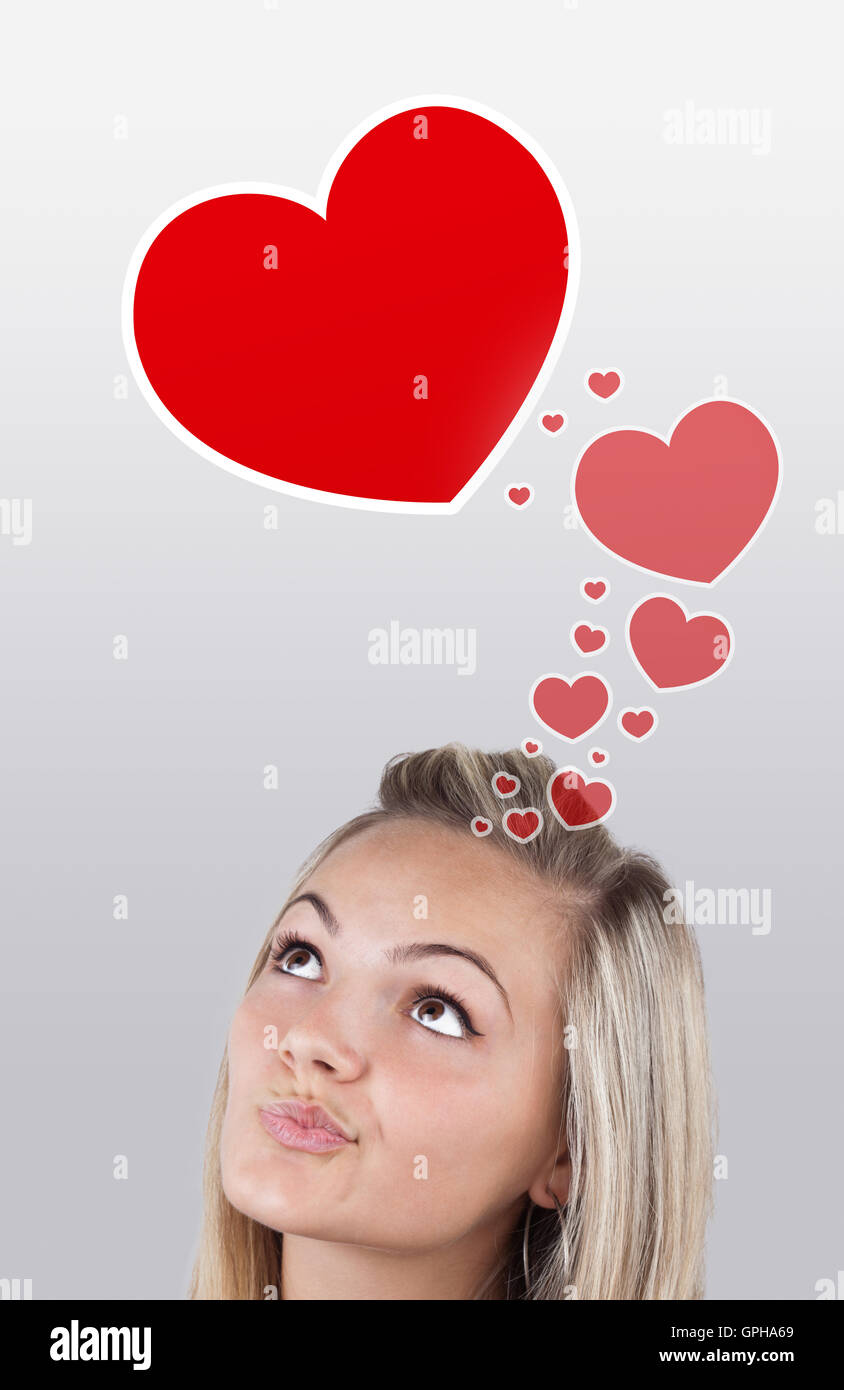 Young girl looking at love type of icons Stock Photo - Alamy
