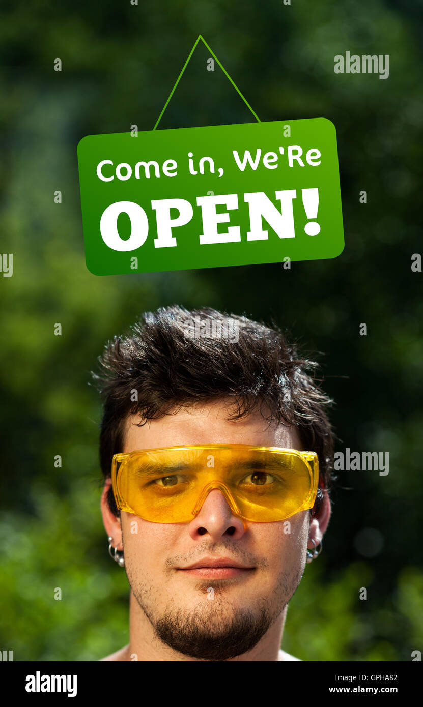 Young persons head looking at closed and open signs Stock Photo - Alamy