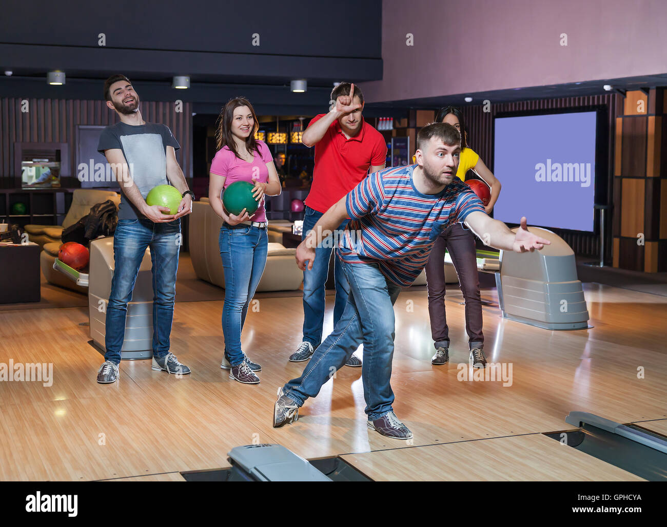 Friends having fun in bowling Stock Photo - Alamy