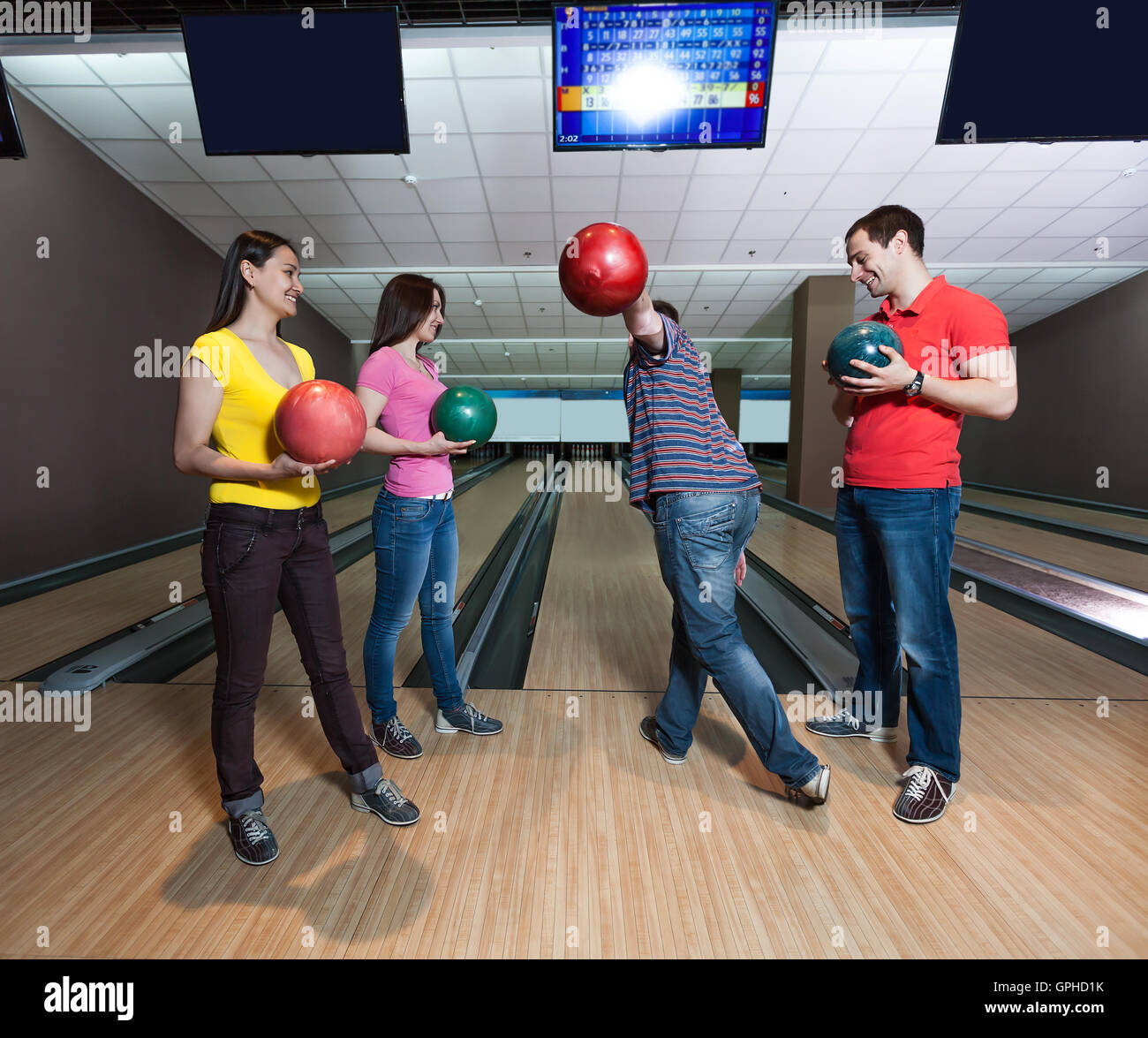 Friends having fun in bowling Stock Photo - Alamy