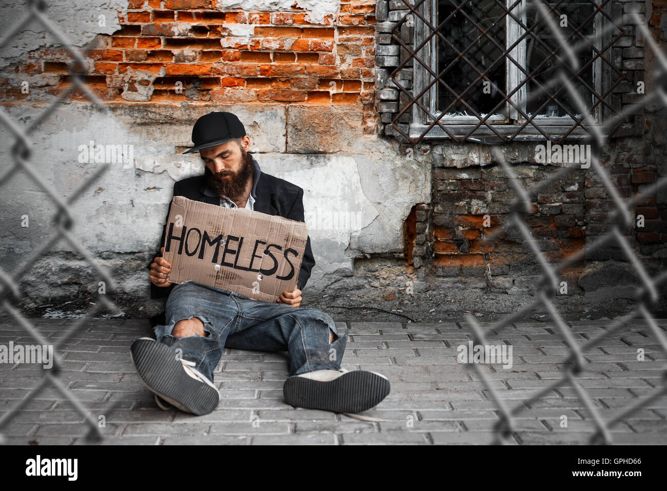 Vagrant with cardboard Stock Photo - Alamy