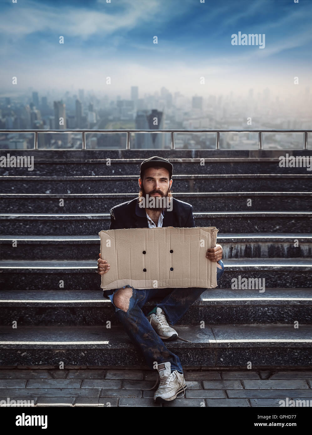 Vagrant with cardboard Stock Photo - Alamy