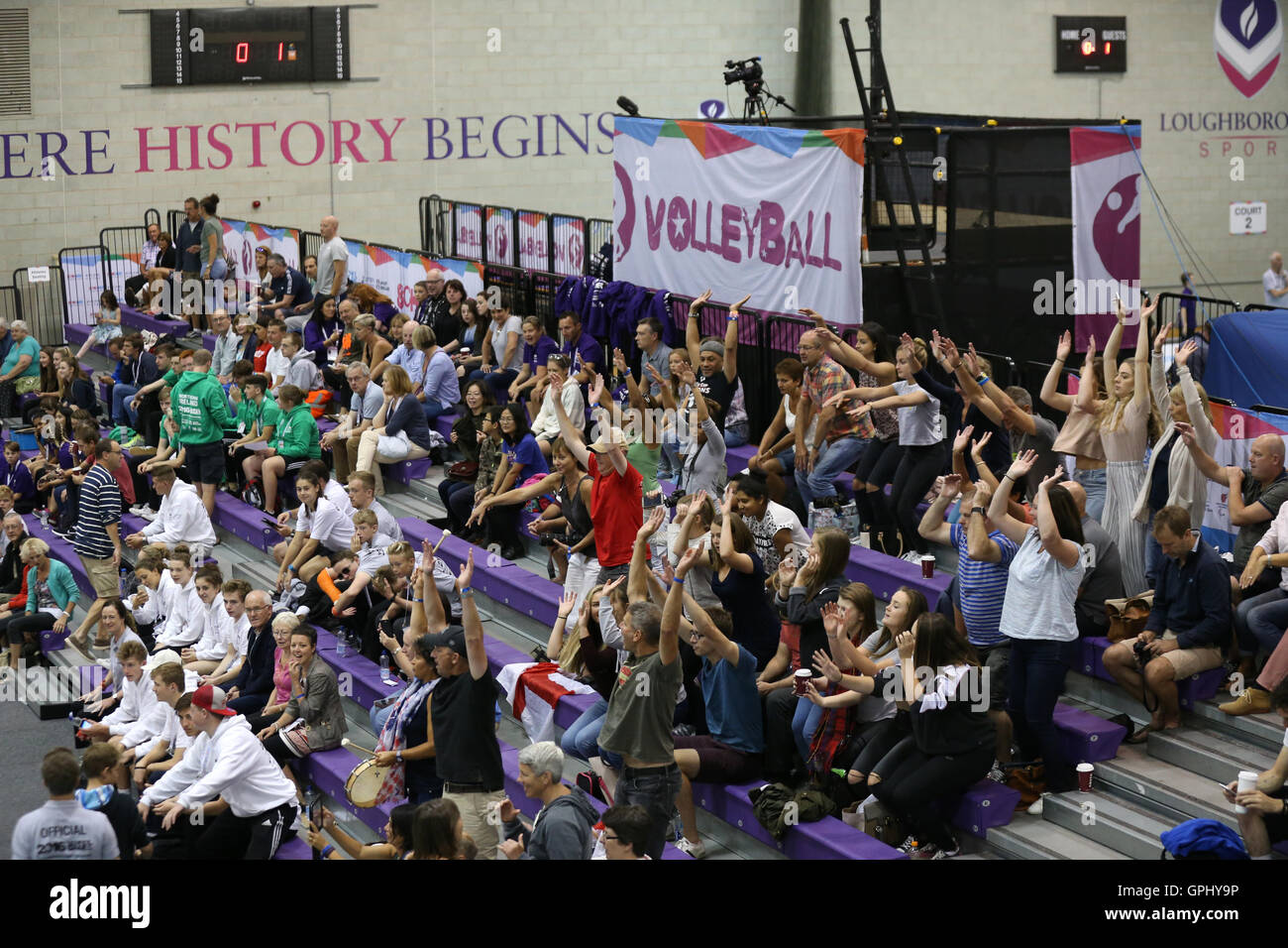Members of the crowd show their support at the volleyball on day four ...